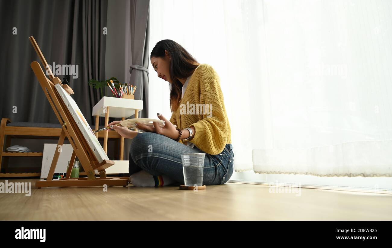 Woman Sitting On Floor Side View