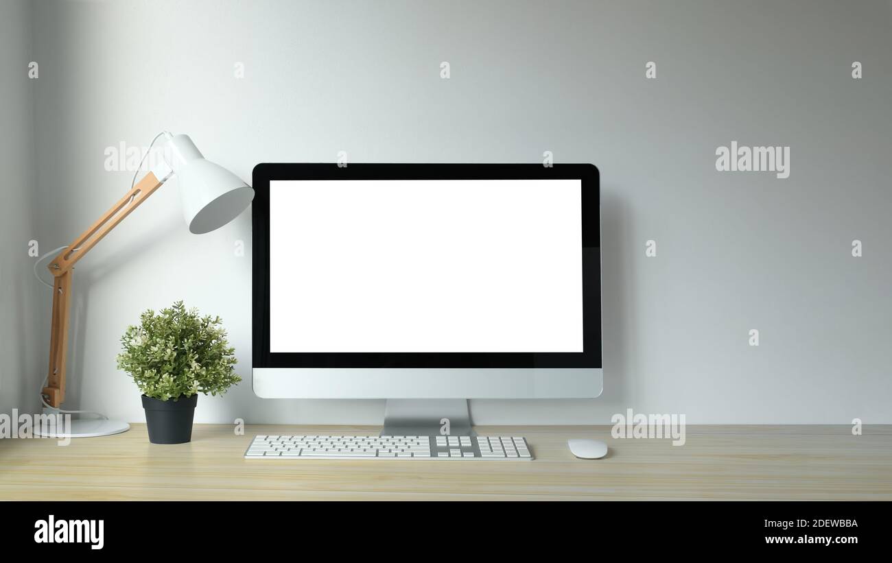 Computer monitor with white blank screen putting on white working desk ...