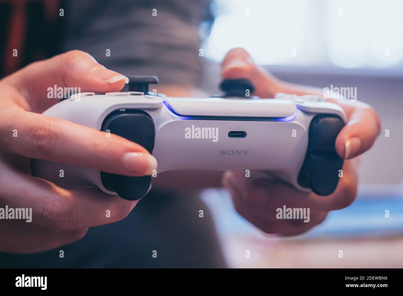 Person holding the PlayStation 5 DualSense gaming controller Stock ...