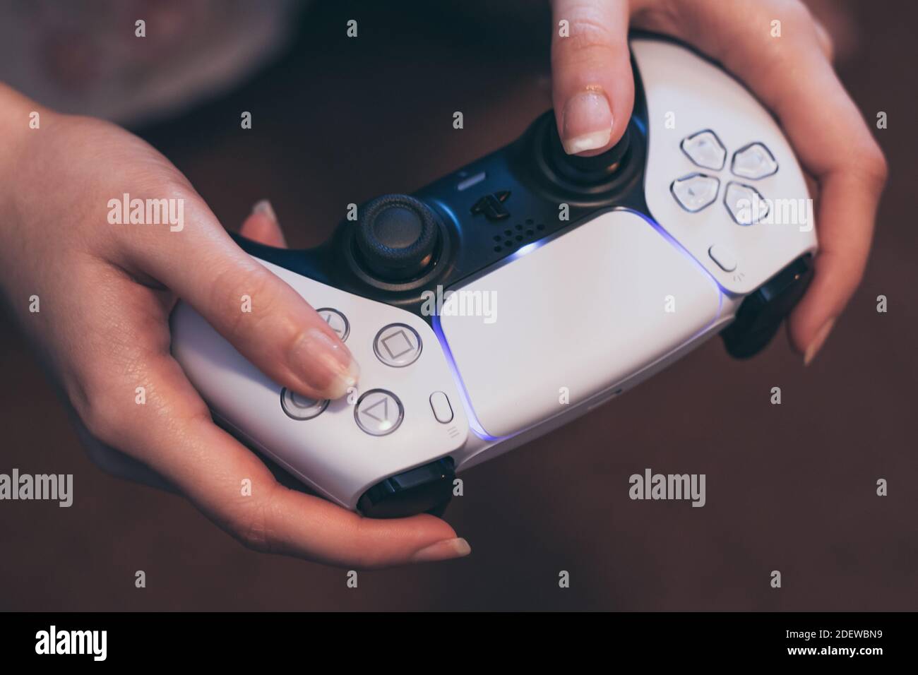 Person holding the PlayStation 5 DualSense gaming controller Stock ...