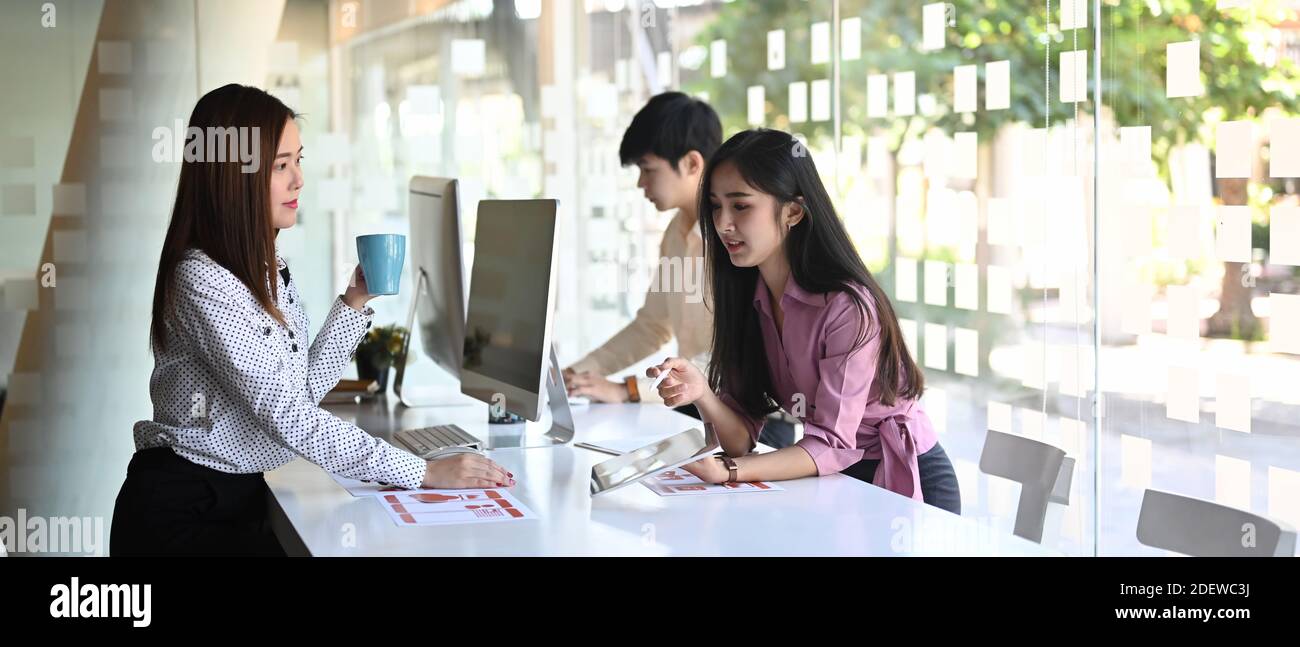 Group of asian ui ux designers are working and designing together a ...