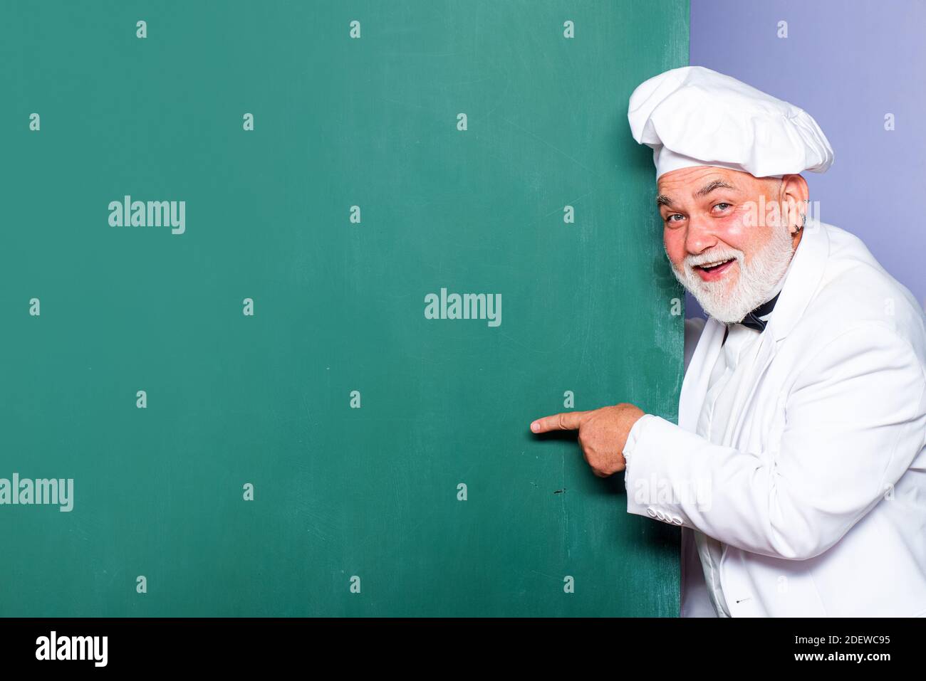 Senior chief cook. Portrait of chief cook with hand sign on blackboard ...