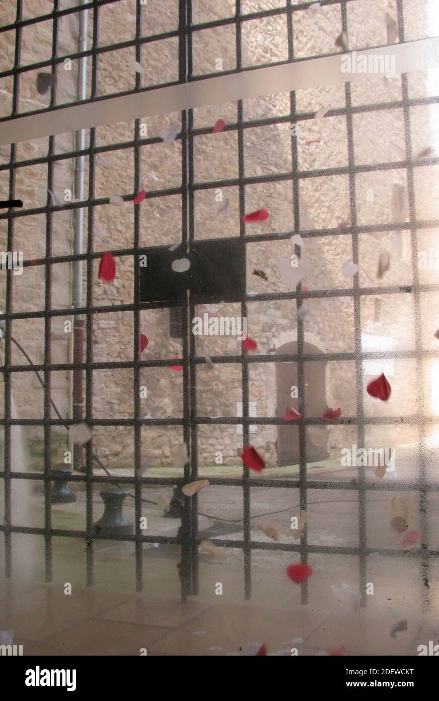 behind bars, serve a sentence in imprisonment, view on a building wall ...