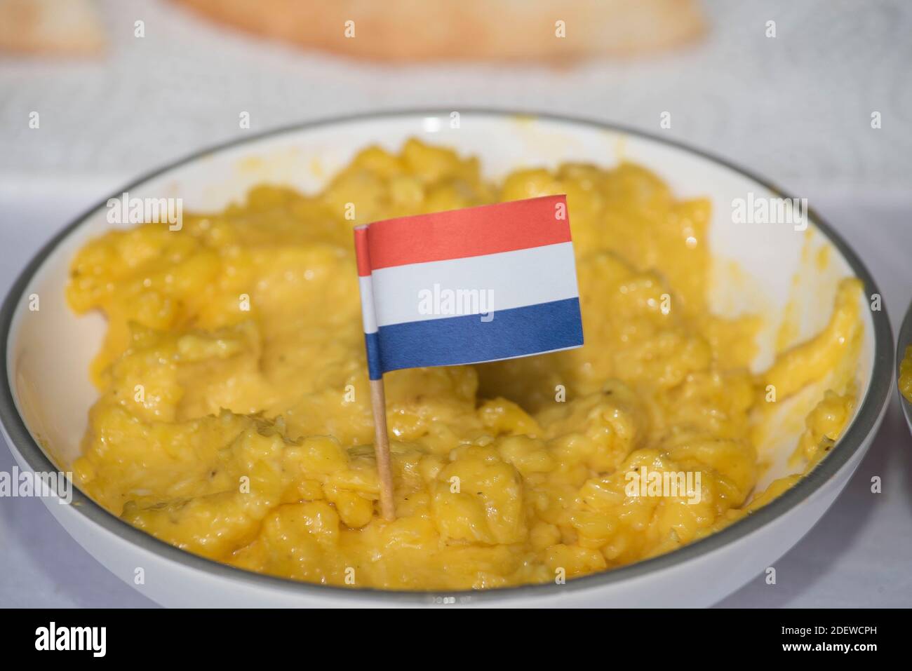 yellow breakfast in a bowl, with a small flag of the netherlands Stock ...