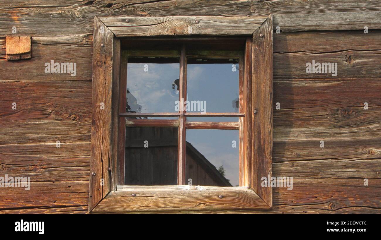 a small wooden window in an old wooden house on the countryside Stock ...