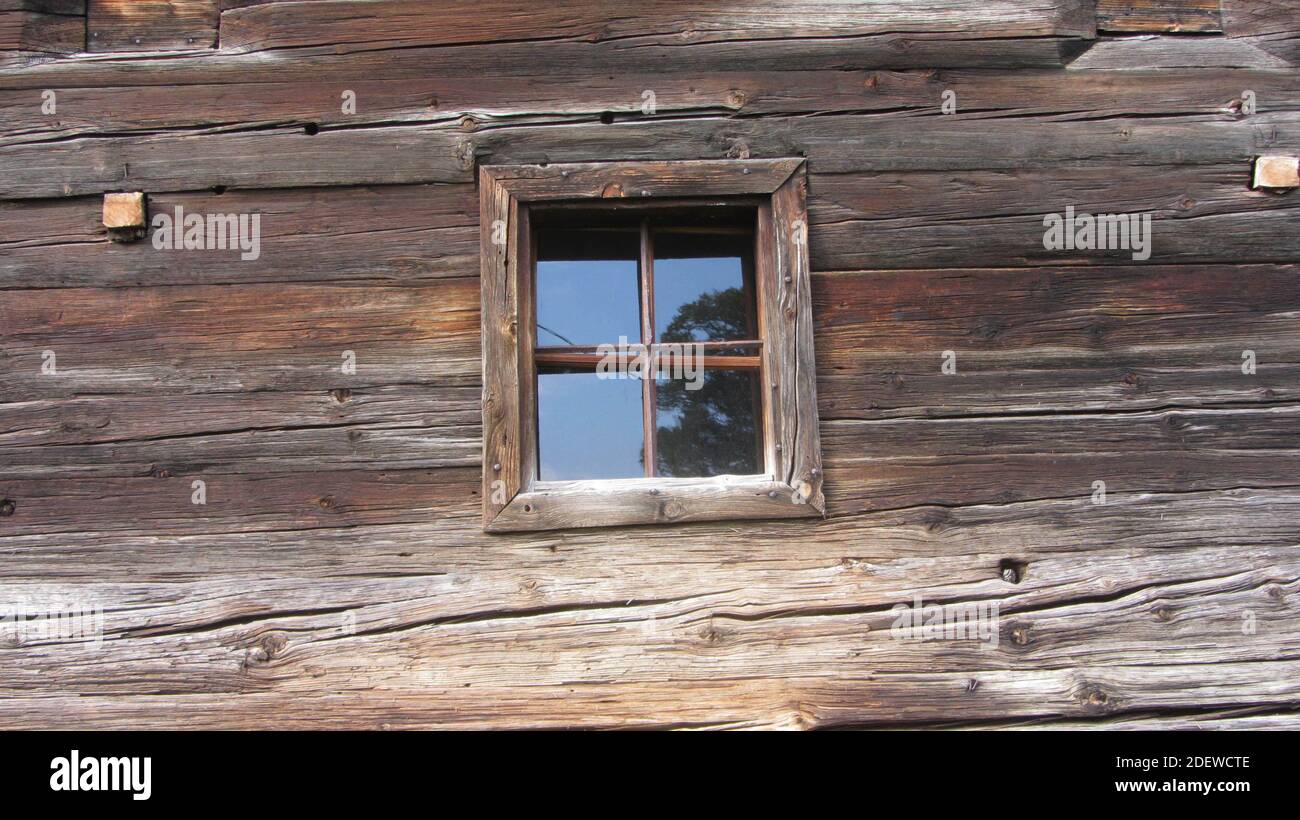 a small wooden window in an old wooden house on the countryside Stock ...