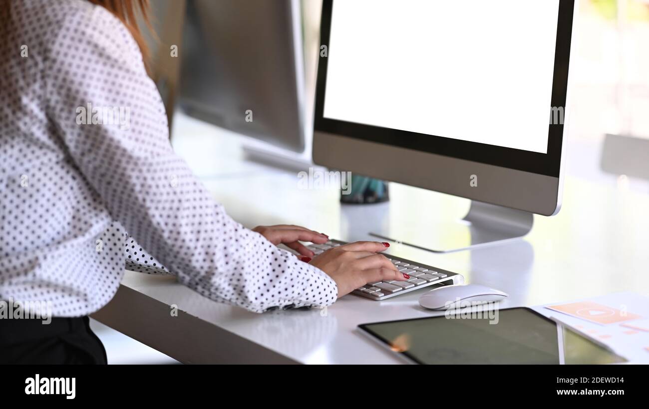 Cropped shot of young serious businesswoman hands typing on keyboard on ...