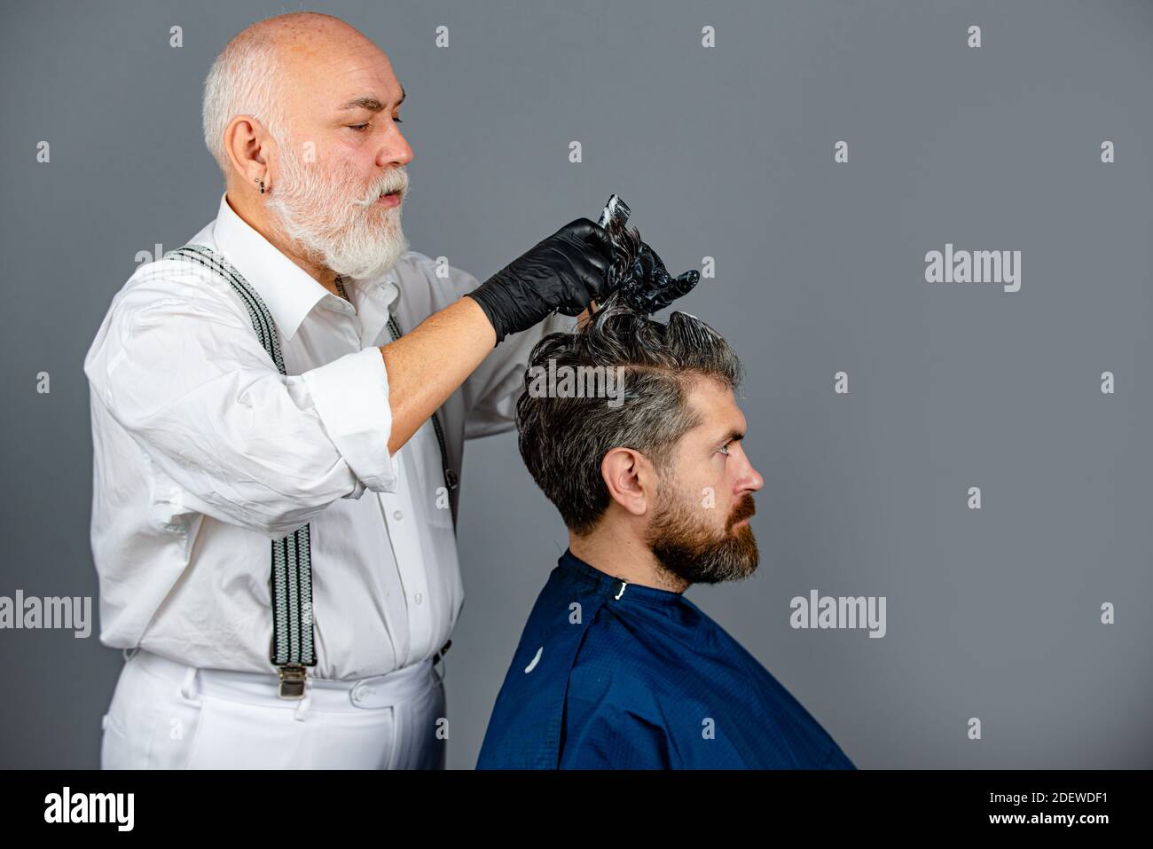 Process of a guy having his hair dyed at hairdresser. Beauty and people ...