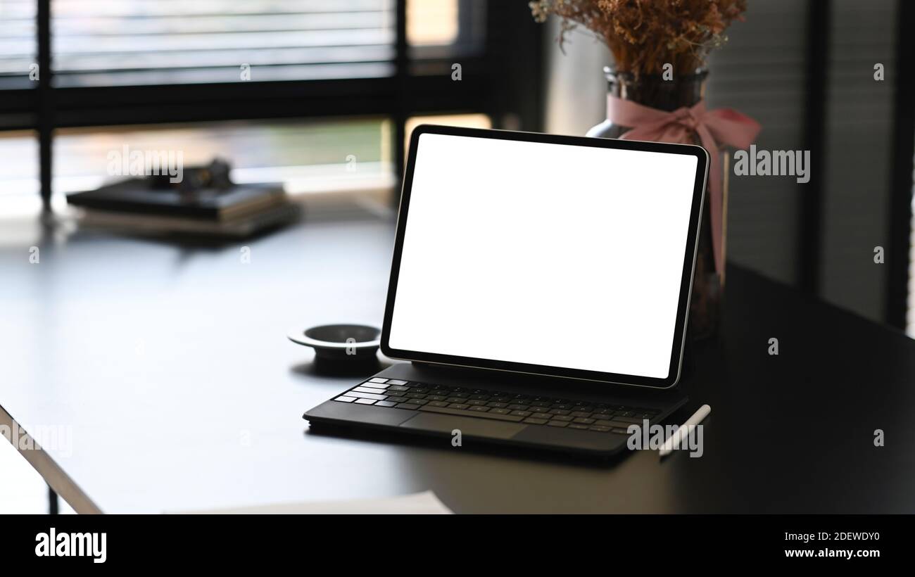 Front view of a computer tablet on modern workspace and blank screen ...