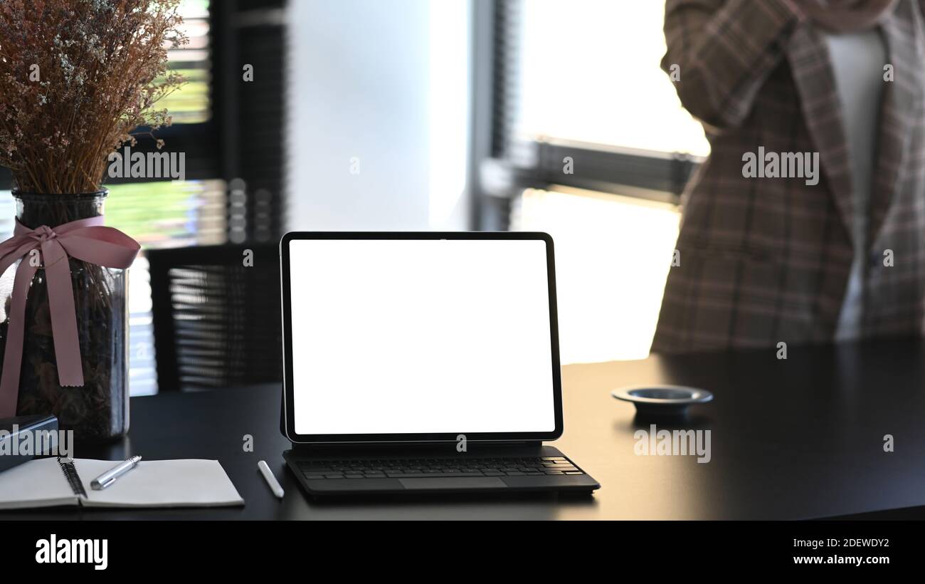 Front view of a computer tablet on the work desk and blank screen for ...