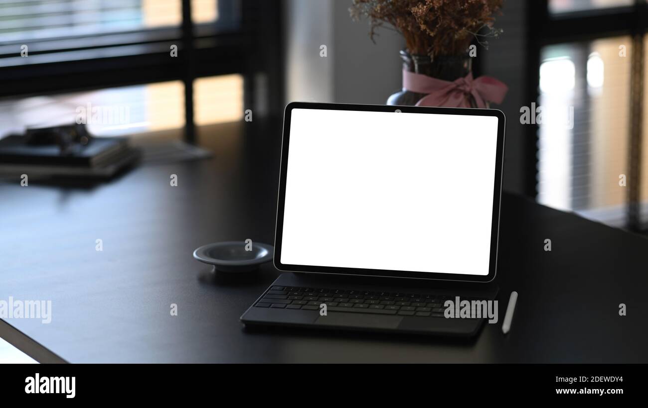 Modern workspace with a blank screen computer tablet. Blank screen for ...