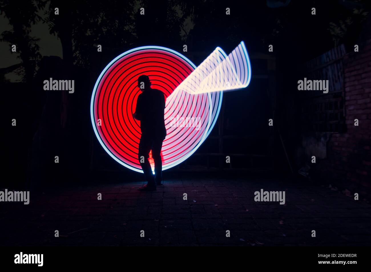 One person standing alone against beautiful color circle LED light ...