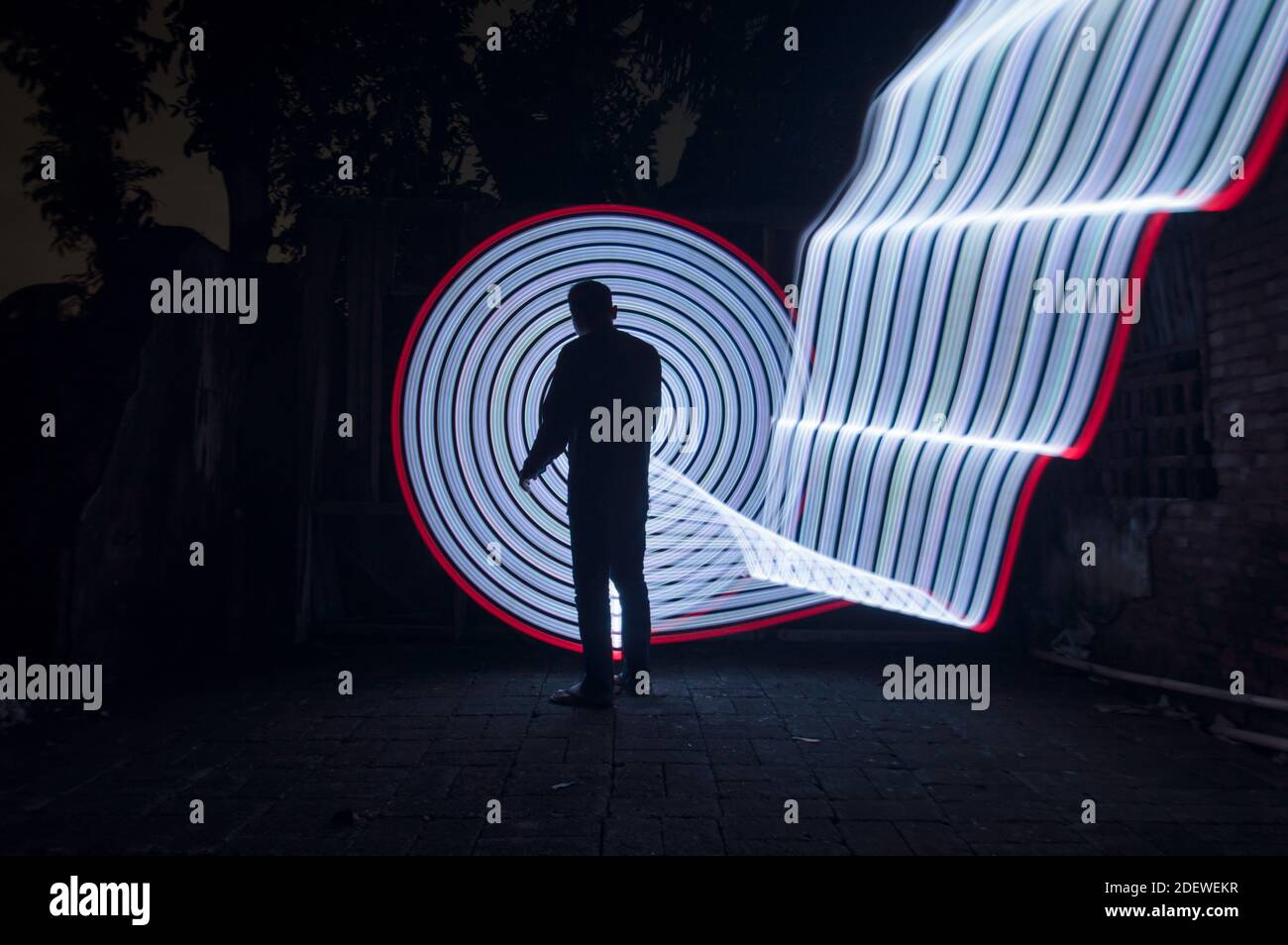 One person standing alone against beautiful color circle LED light ...