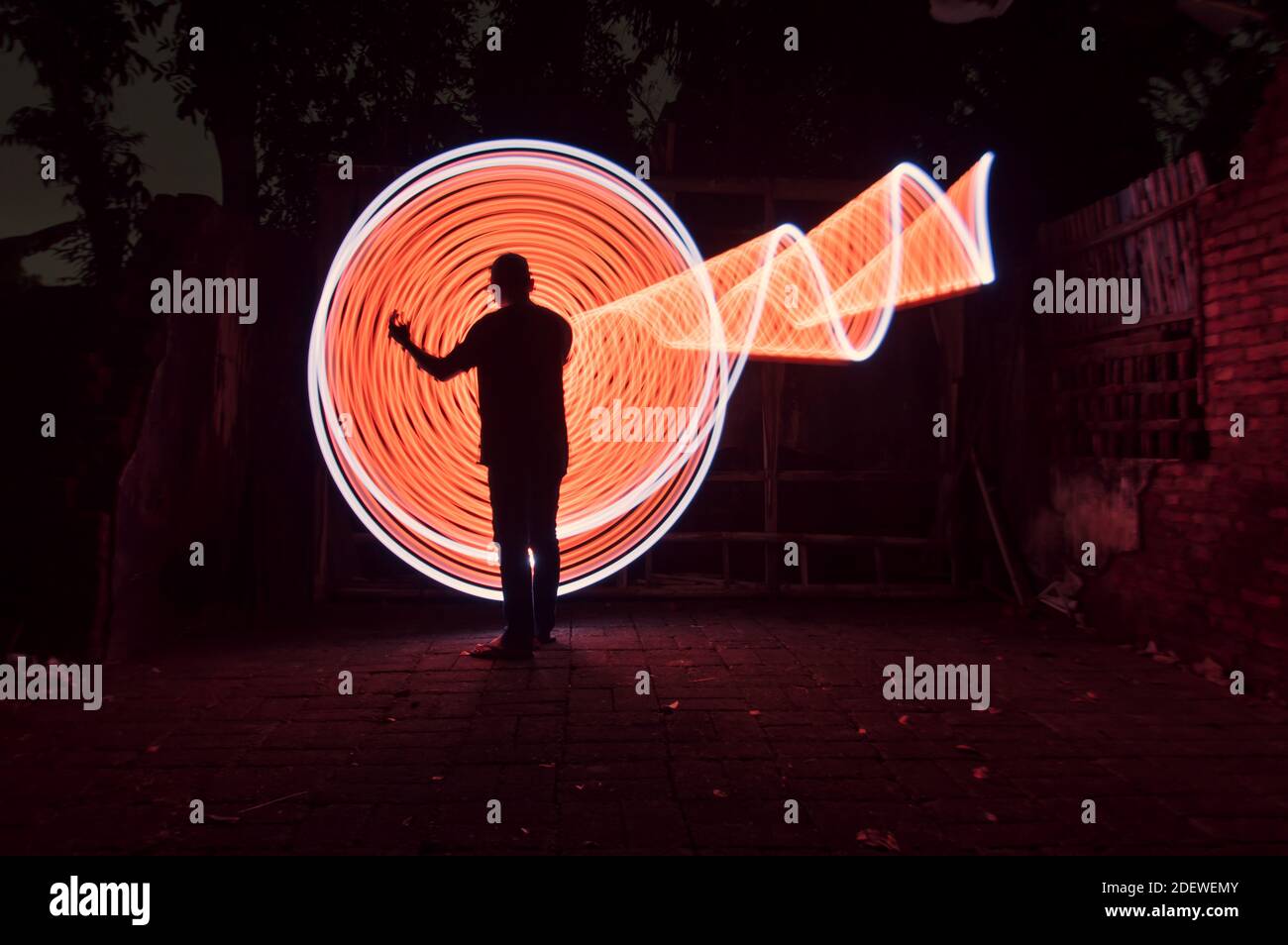 One person standing alone against beautiful color circle LED light ...