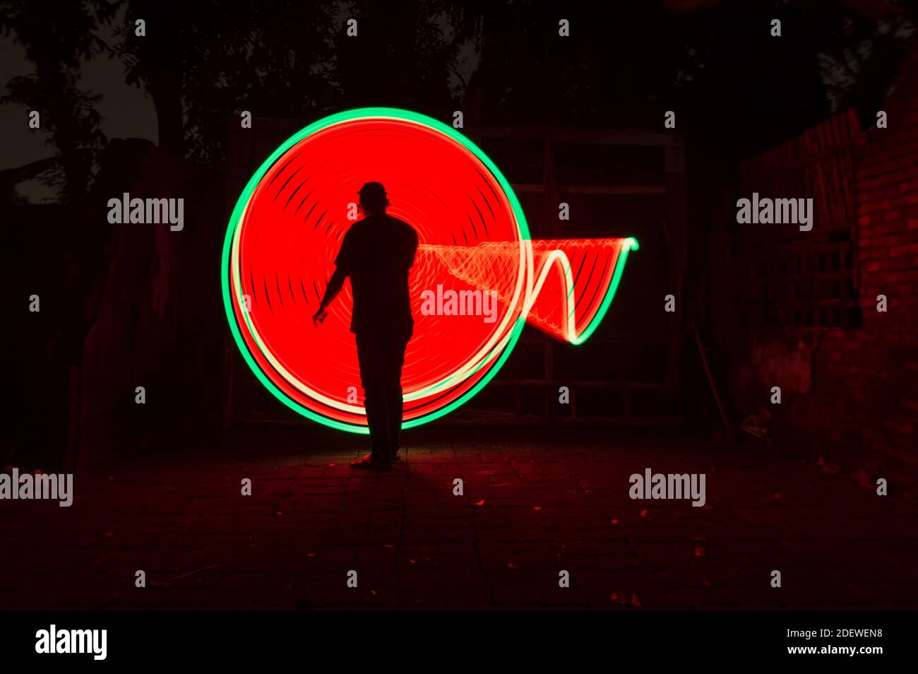 One person standing alone against beautiful color circle LED light ...