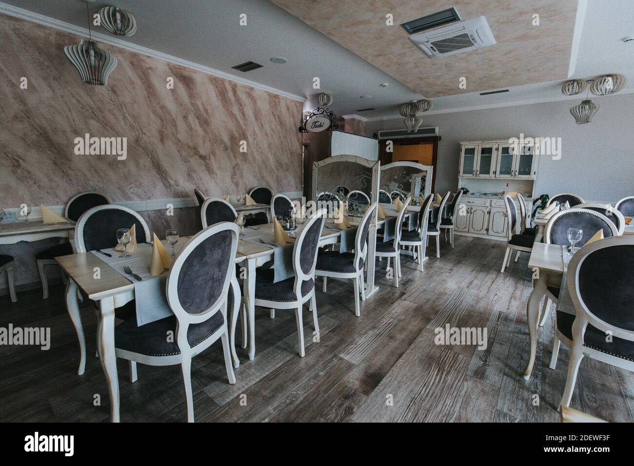 A view inside a restaurant with arranged tables and chairs Stock Photo ...