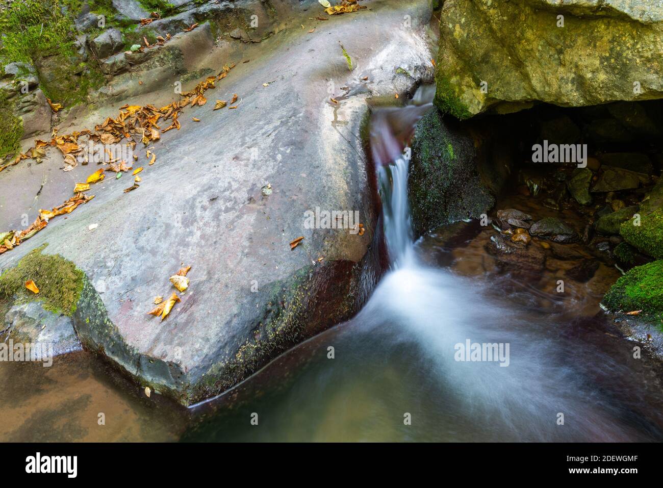 Close-up of the waterfall movement. The stream of water flows around ...