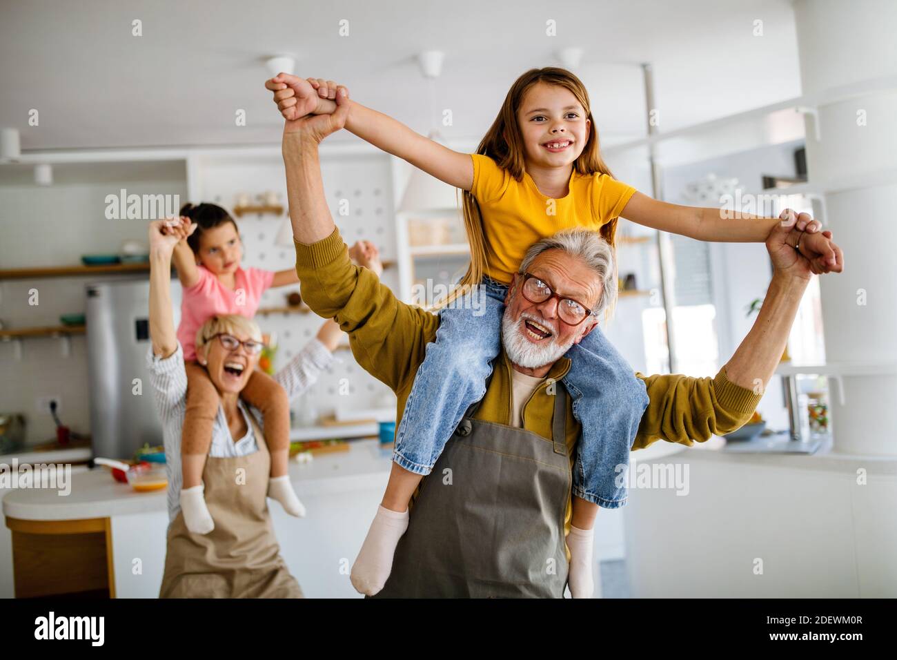 Grandchildren having fun, playing with grandparents at home Stock Photo ...