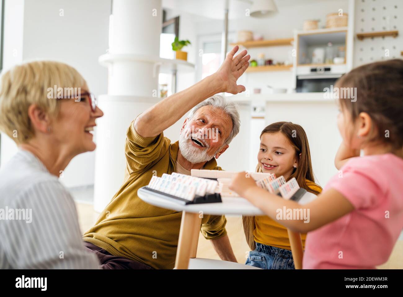Grandchildren having fun, playing with grandparents at home Stock Photo ...