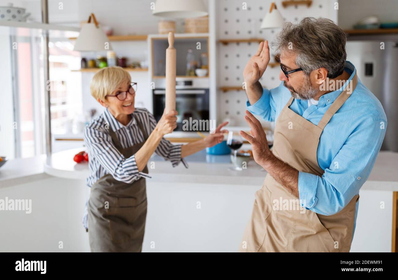 Family quarrel. Upset, scared senior man against angry woman at home ...