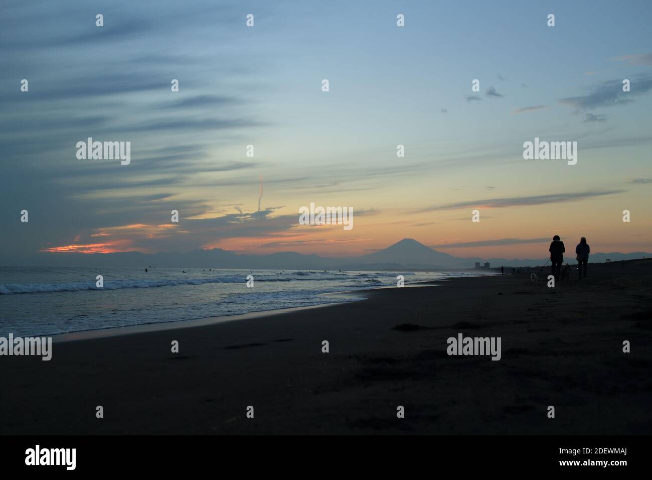 sunset scene of coastal beach, human silhouette and Mt. Fuji, natural ...