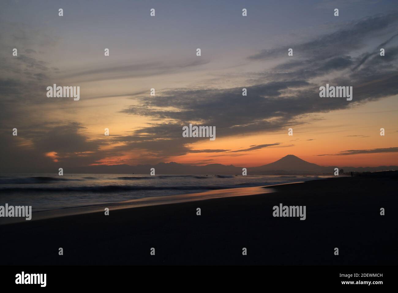 sunset scene of coastal beach, human silhouette and Mt. Fuji, natural ...