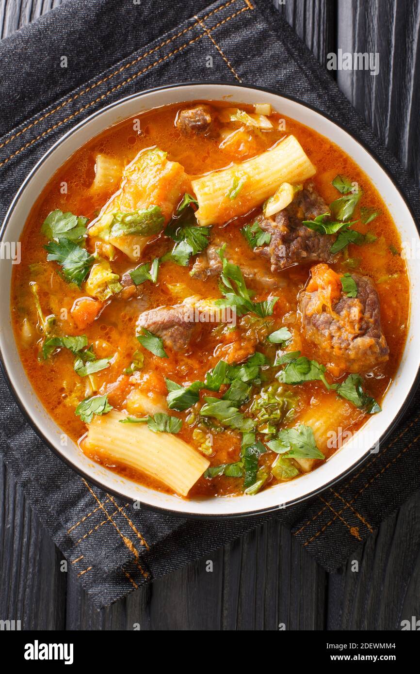 Haitian joumou beef and pumpkin soup closeup in the plate on the table ...