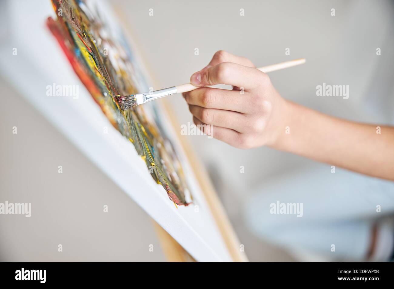 Young artist hand painting a picture in the home studio Stock Photo - Alamy