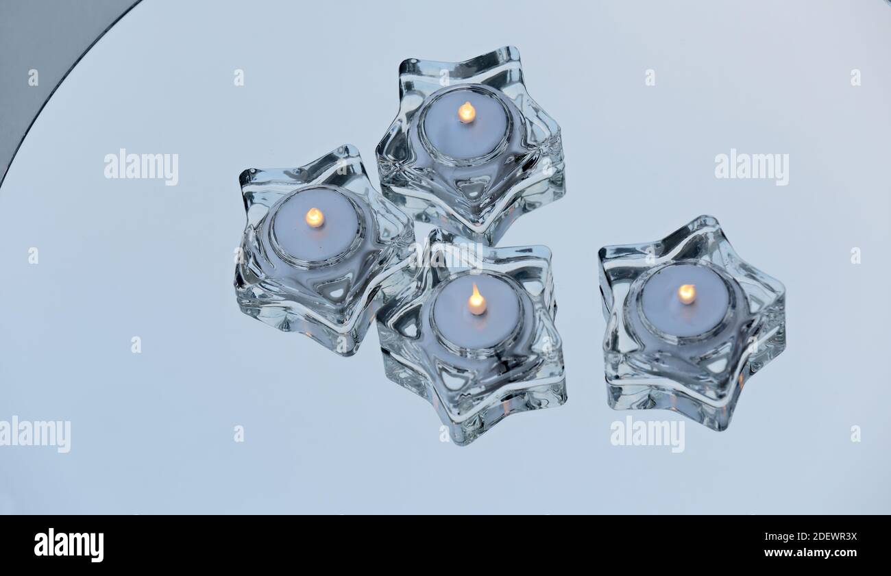 Four star formed glass led lights burning on a mirror Stock Photo - Alamy