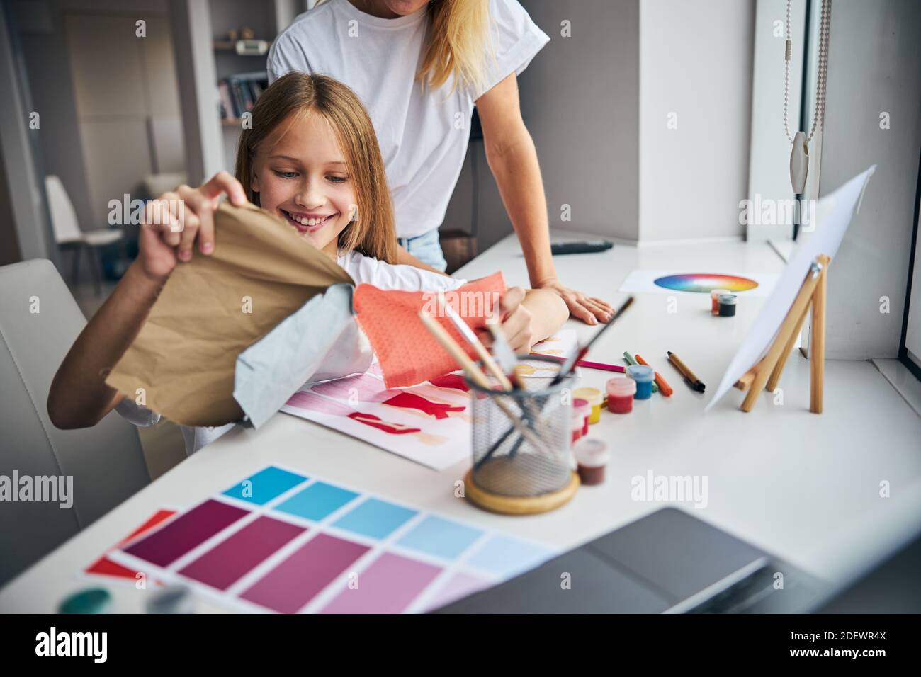 Merry young stylist working in her studio Stock Photo - Alamy