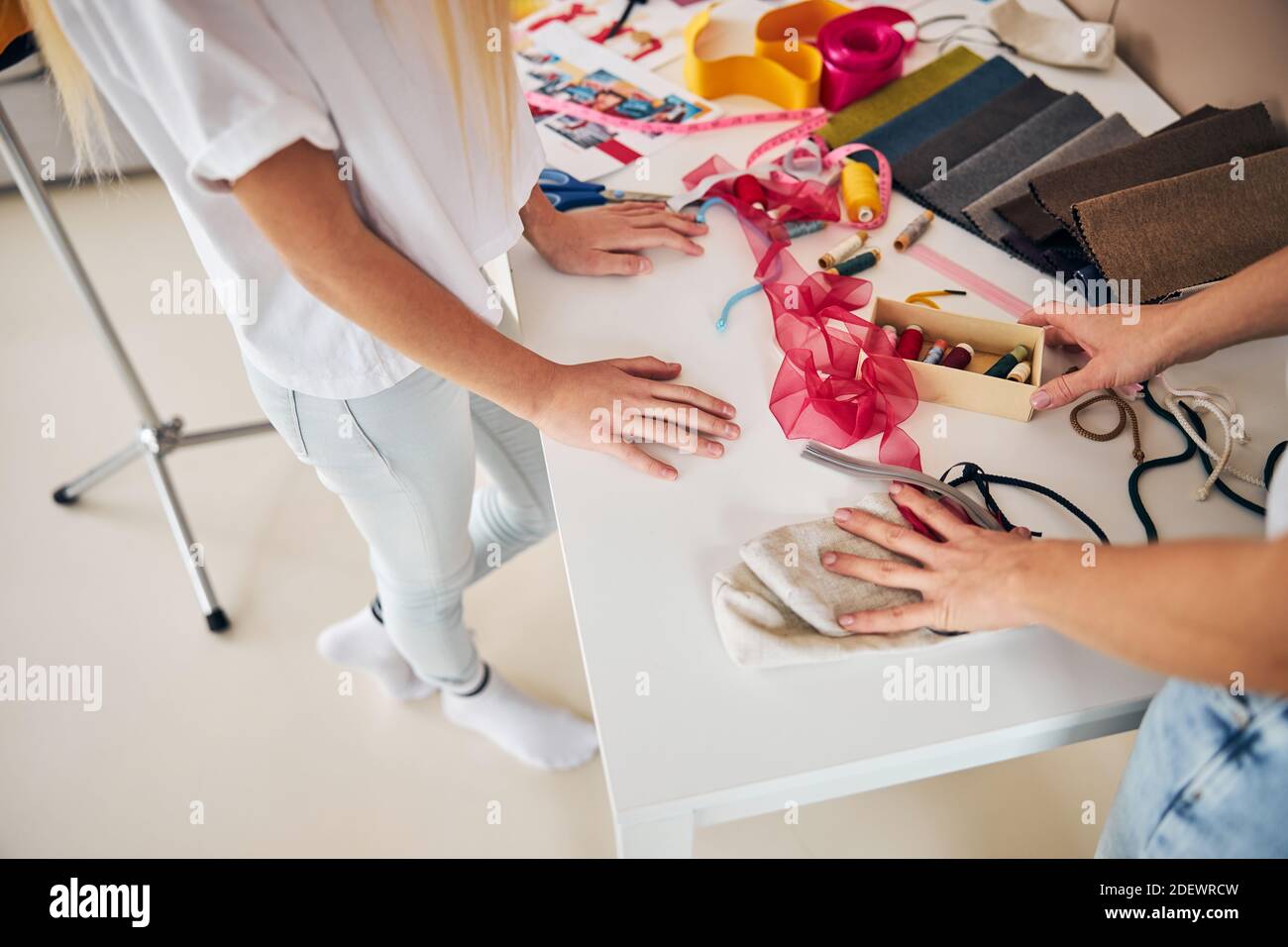 Two creative people working on a new fashion design Stock Photo - Alamy