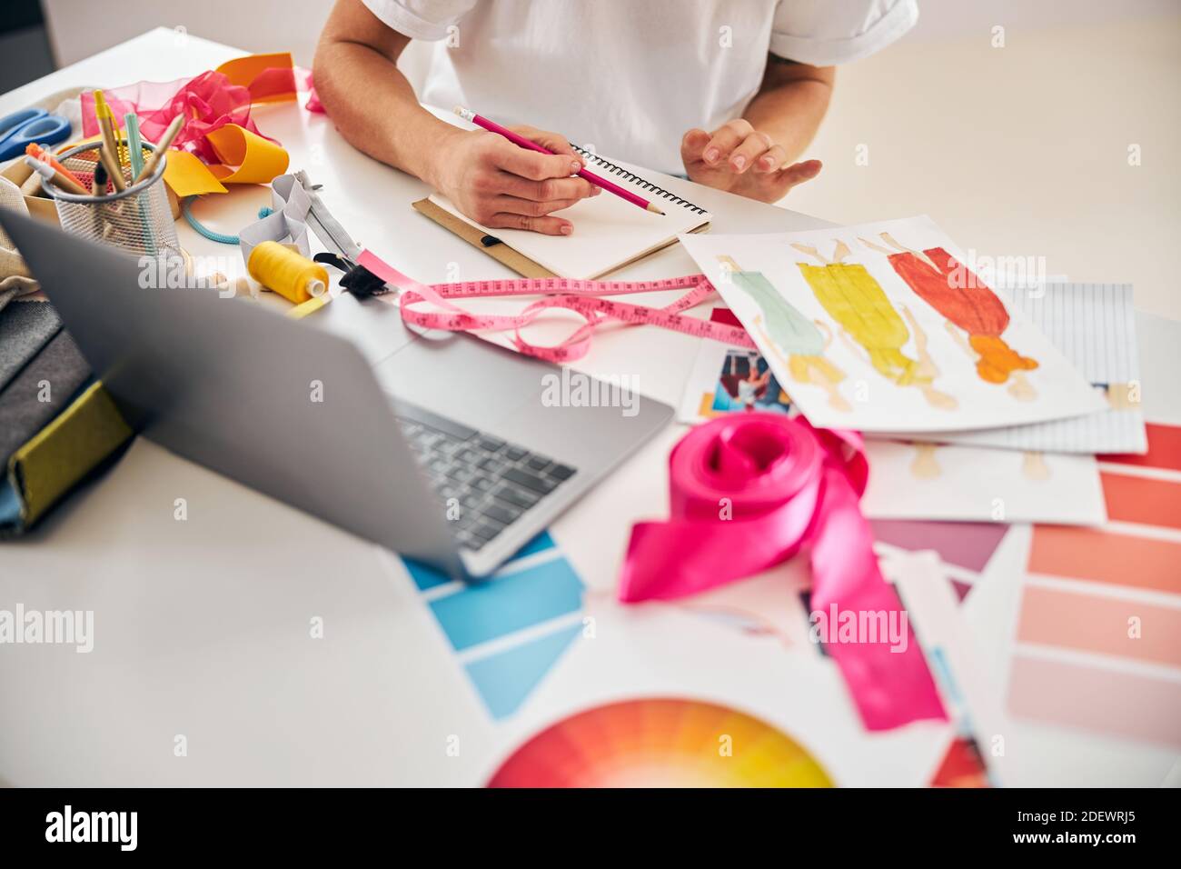 Stylist noting down ideas in her notebook Stock Photo - Alamy