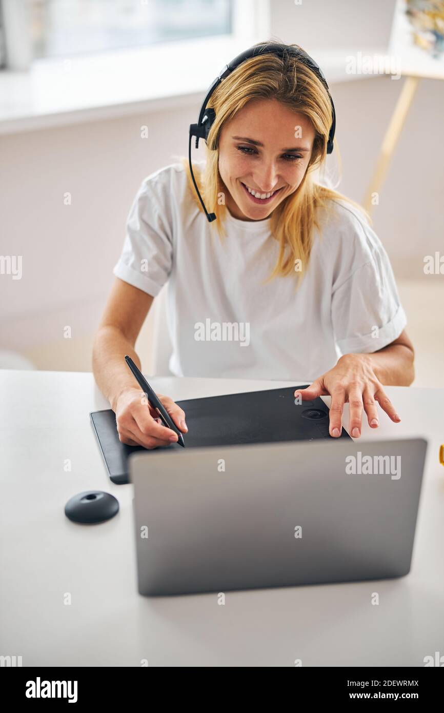 Artist creating digital art in her at-home studio Stock Photo - Alamy
