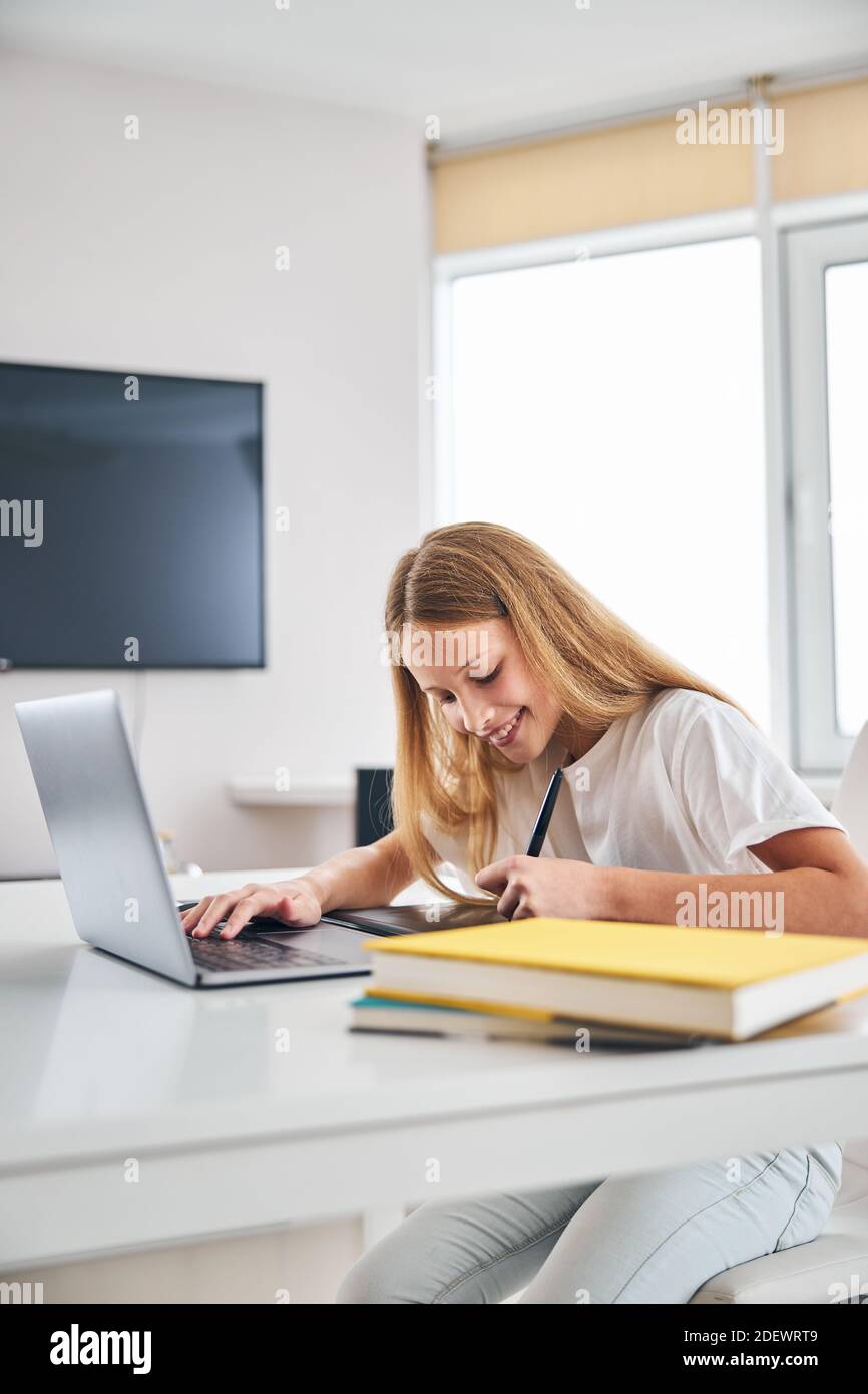 Smiling beautiful girl involved in digital art Stock Photo - Alamy