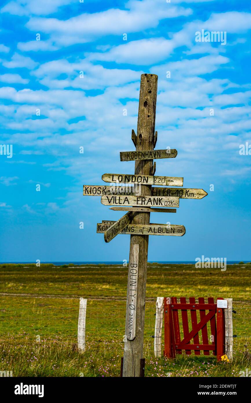 Old wooden signpost showing direction and distances to various ...