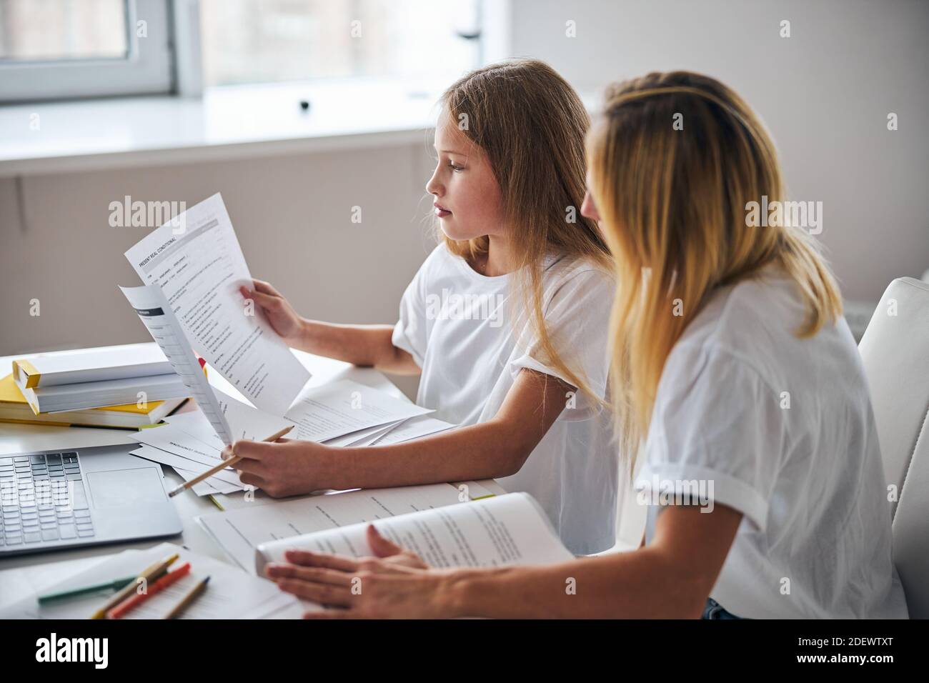 Adolescent girl keeping two papers in her hands Stock Photo - Alamy