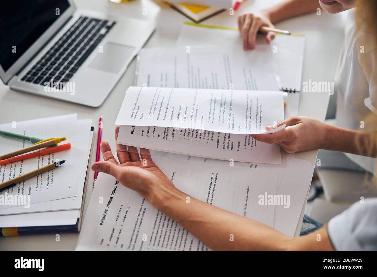 Young person revising the learning materials with her mother Stock ...