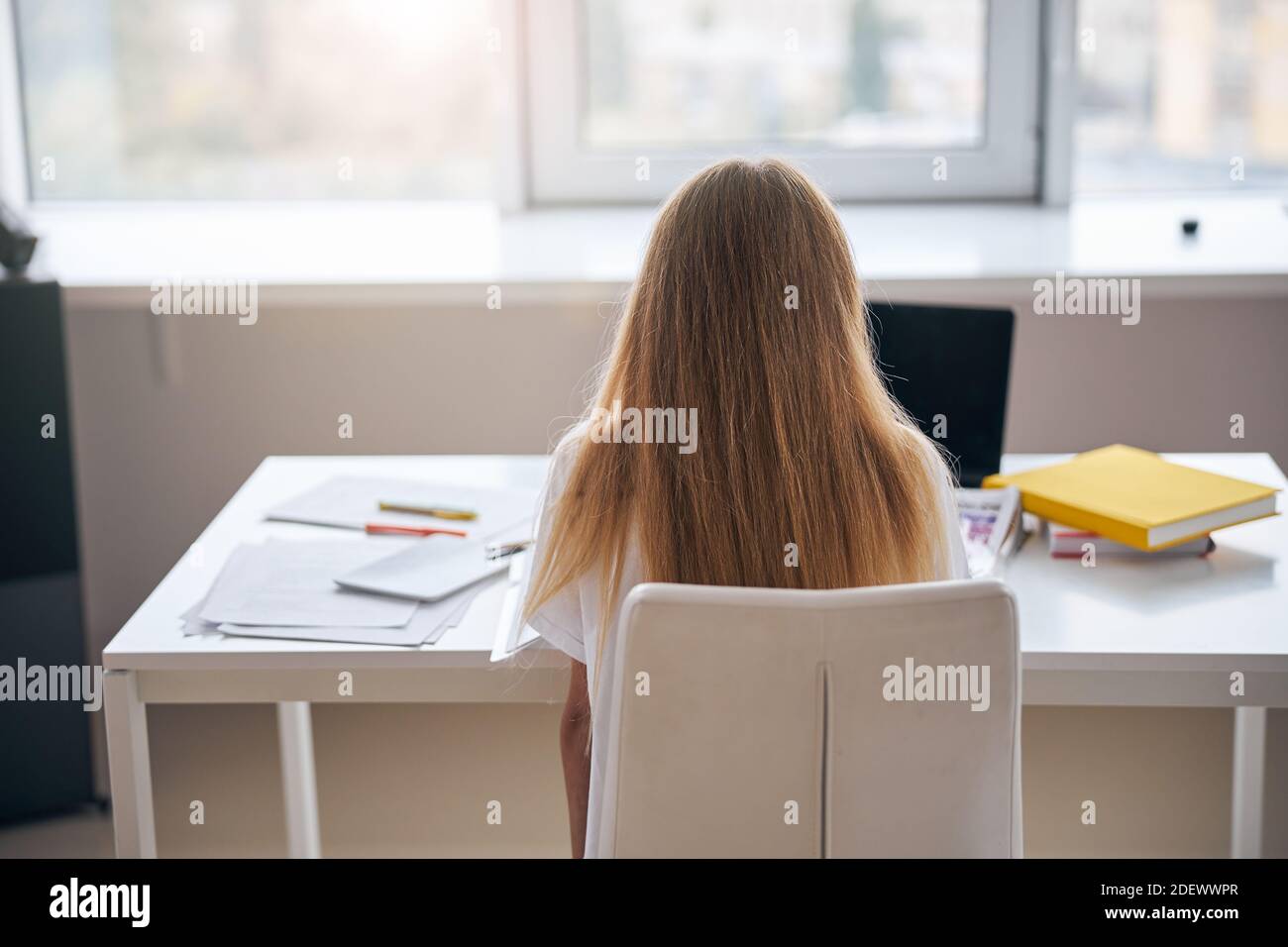 Female student sitting with her back to the camera Stock Photo - Alamy