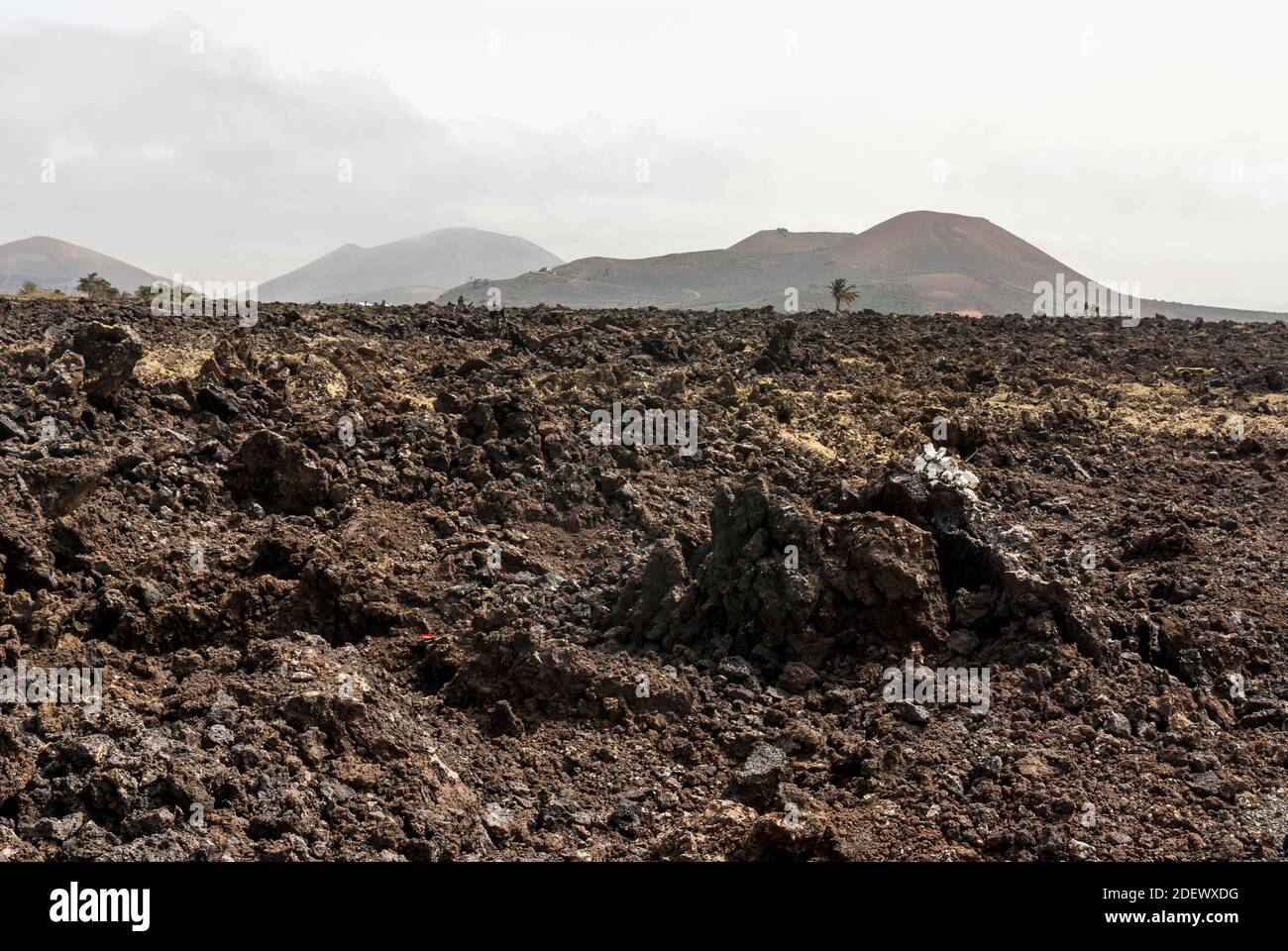 View of a volcanic landscape with mountains on horizon Stock Photo - Alamy