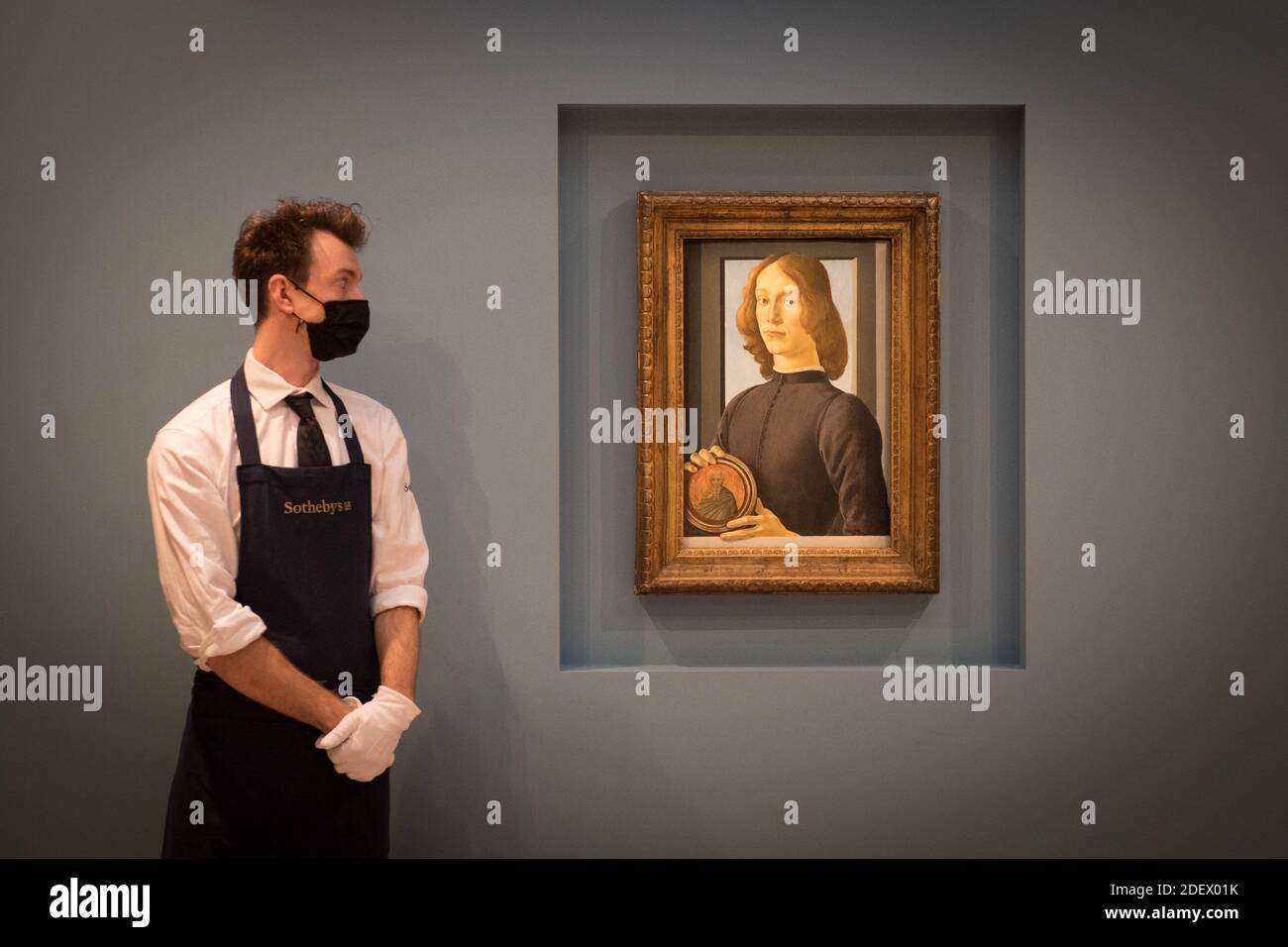 A Sotheby's gallery assitant looks at one of Botticelli's portraits ...