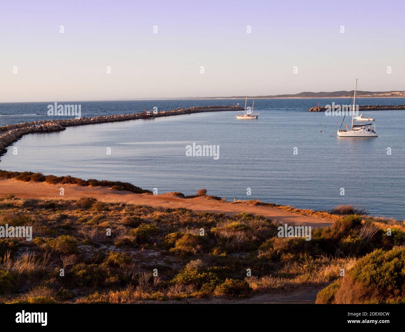 Port Denison harbour and breakwaters at sunset from Fishermens Memorial ...