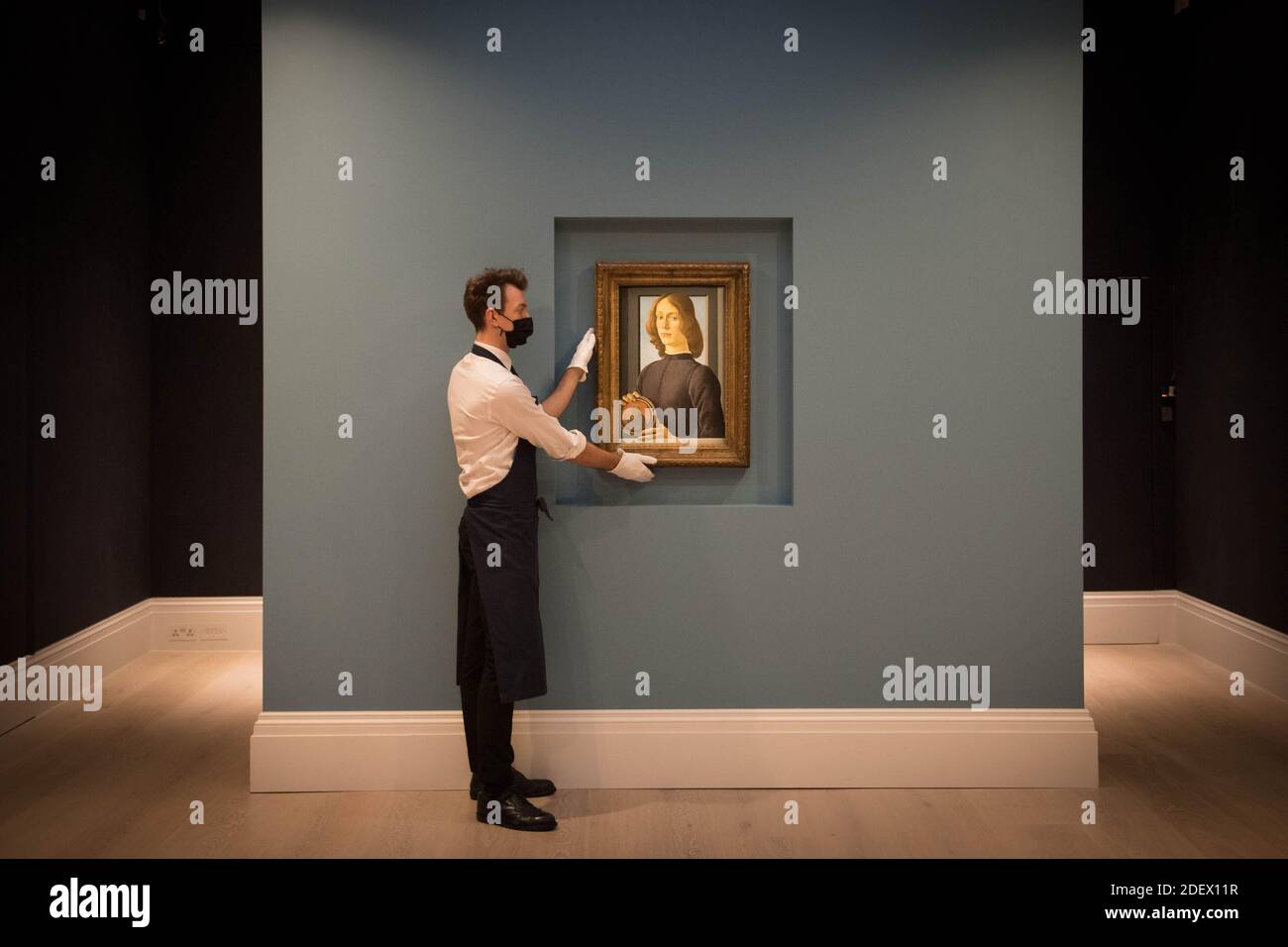 A Sotheby's gallery assistant adjusts one of Renaissance master Sandro ...