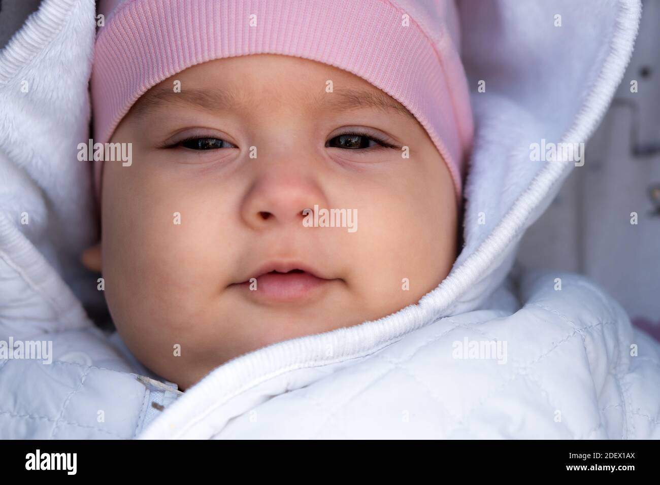 infant, childhood, emotion concept - close-up of cute smiling portrait face of brown-eyed chubby ...