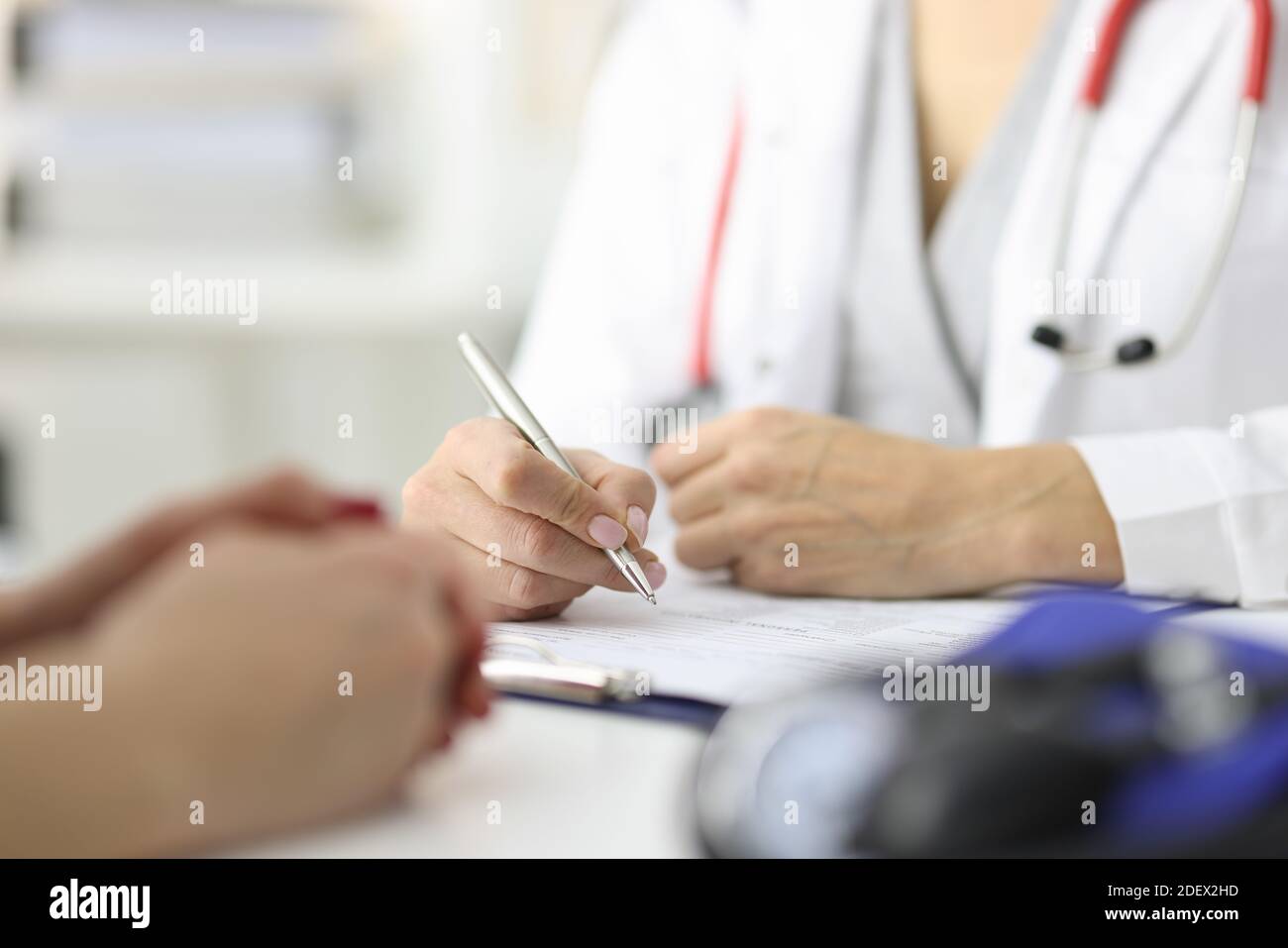 Hands of doctor and patient on work table in medical office Stock Photo ...