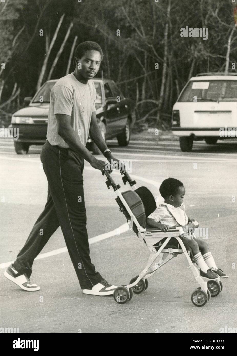 Nigerian tennis player Nduka Odizor with his son, 1980s Stock Photo - Alamy