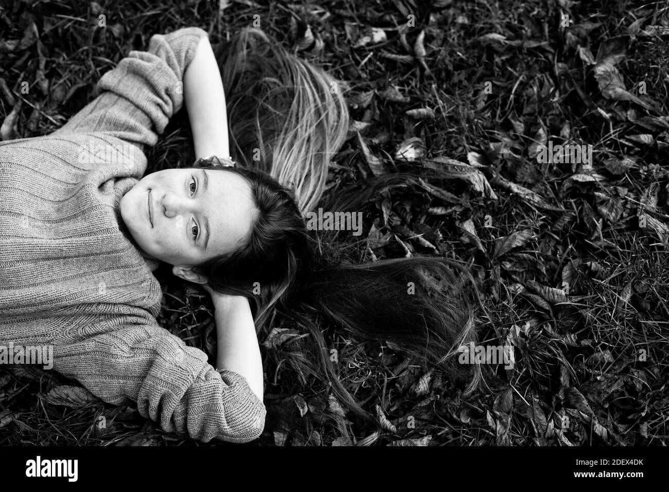 Girl laying on the ground hi-res stock photography and images - Alamy
