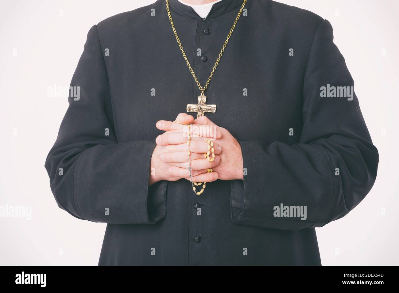Catholic priest's hands holding the rosary Stock Photo - Alamy