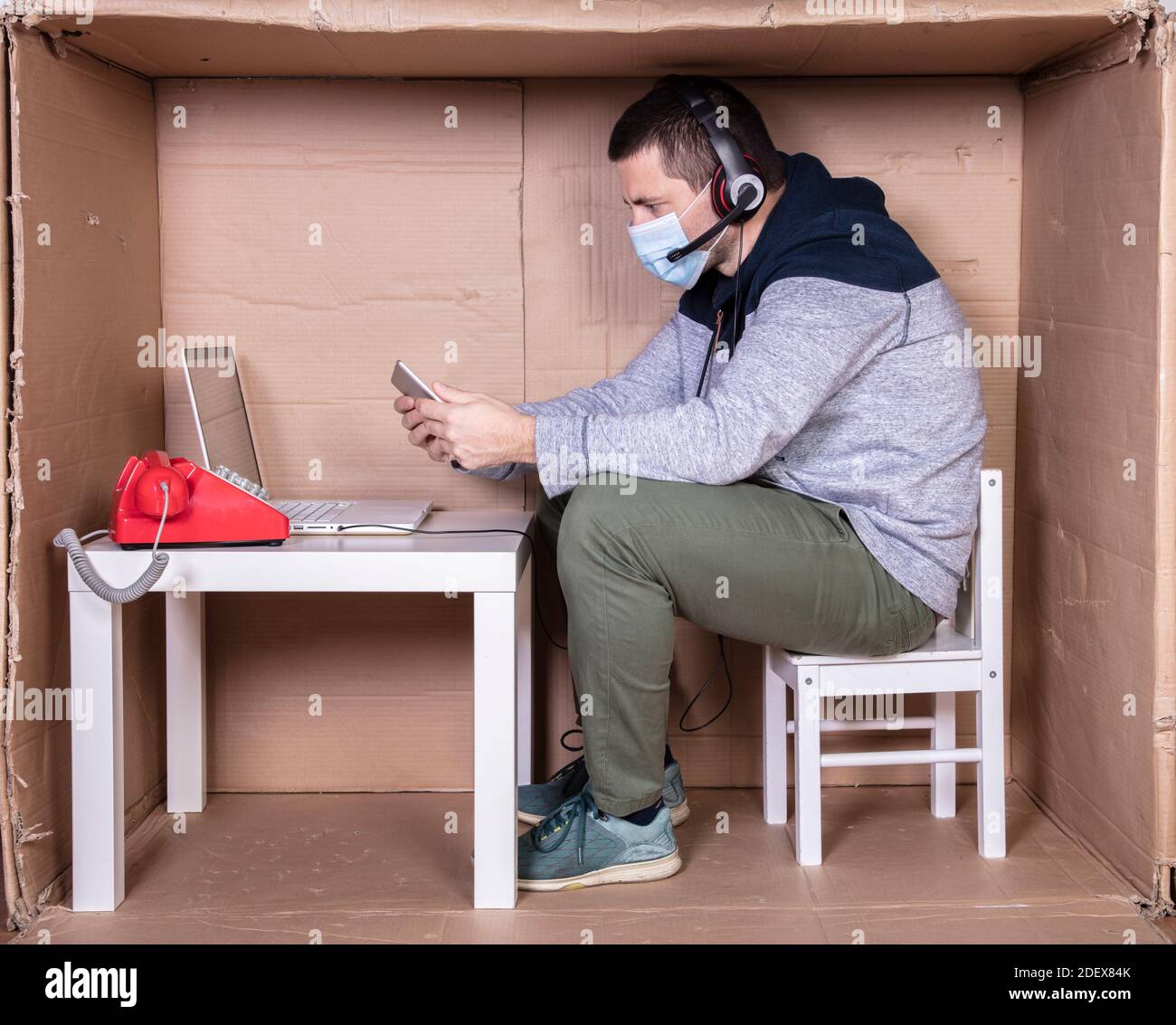 employee works from his own cardboard office to isolate himself from ...