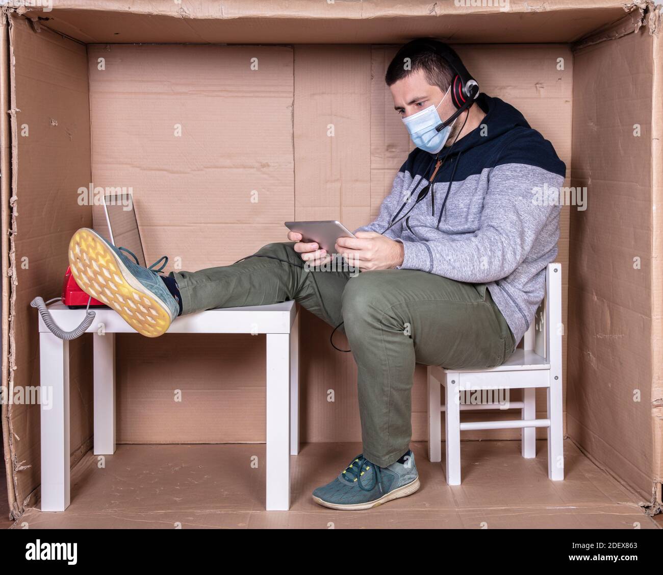 employee works from his own cardboard office to isolate himself from ...
