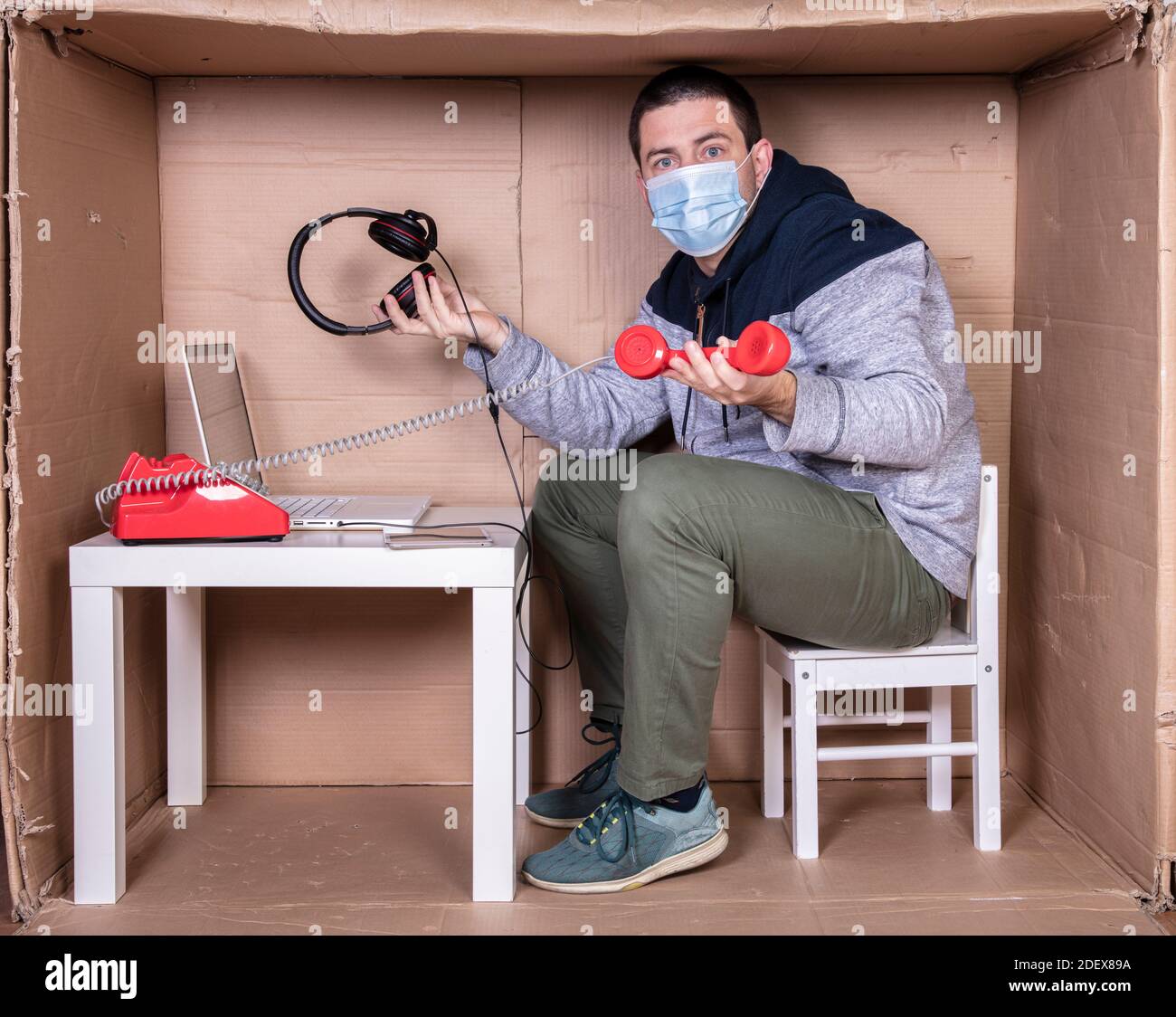 employee works from his own cardboard office to isolate himself from ...
